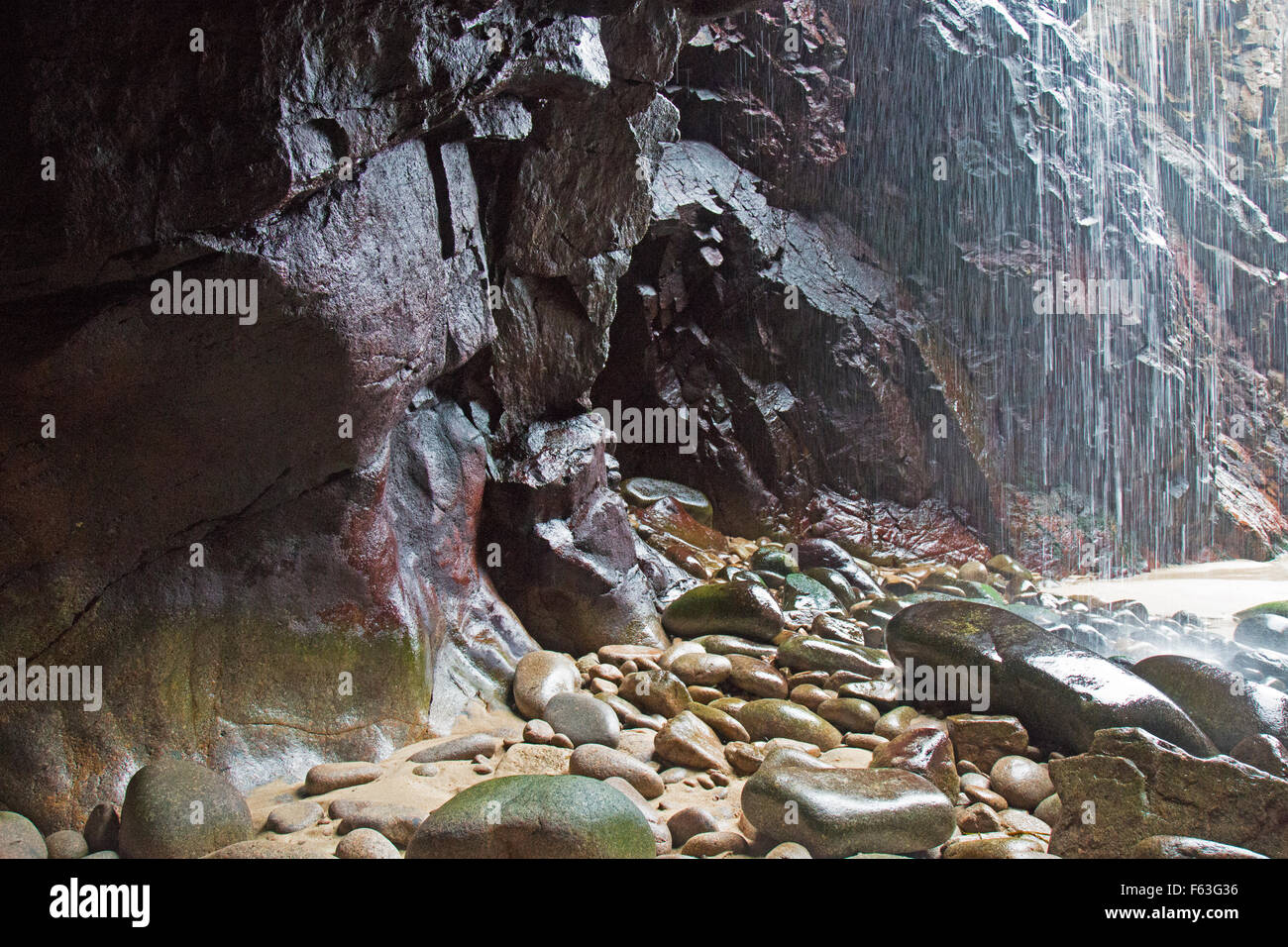 Waterfall beneath rocks in Plemont Bay, Jersey, Channel Islands Stock ...