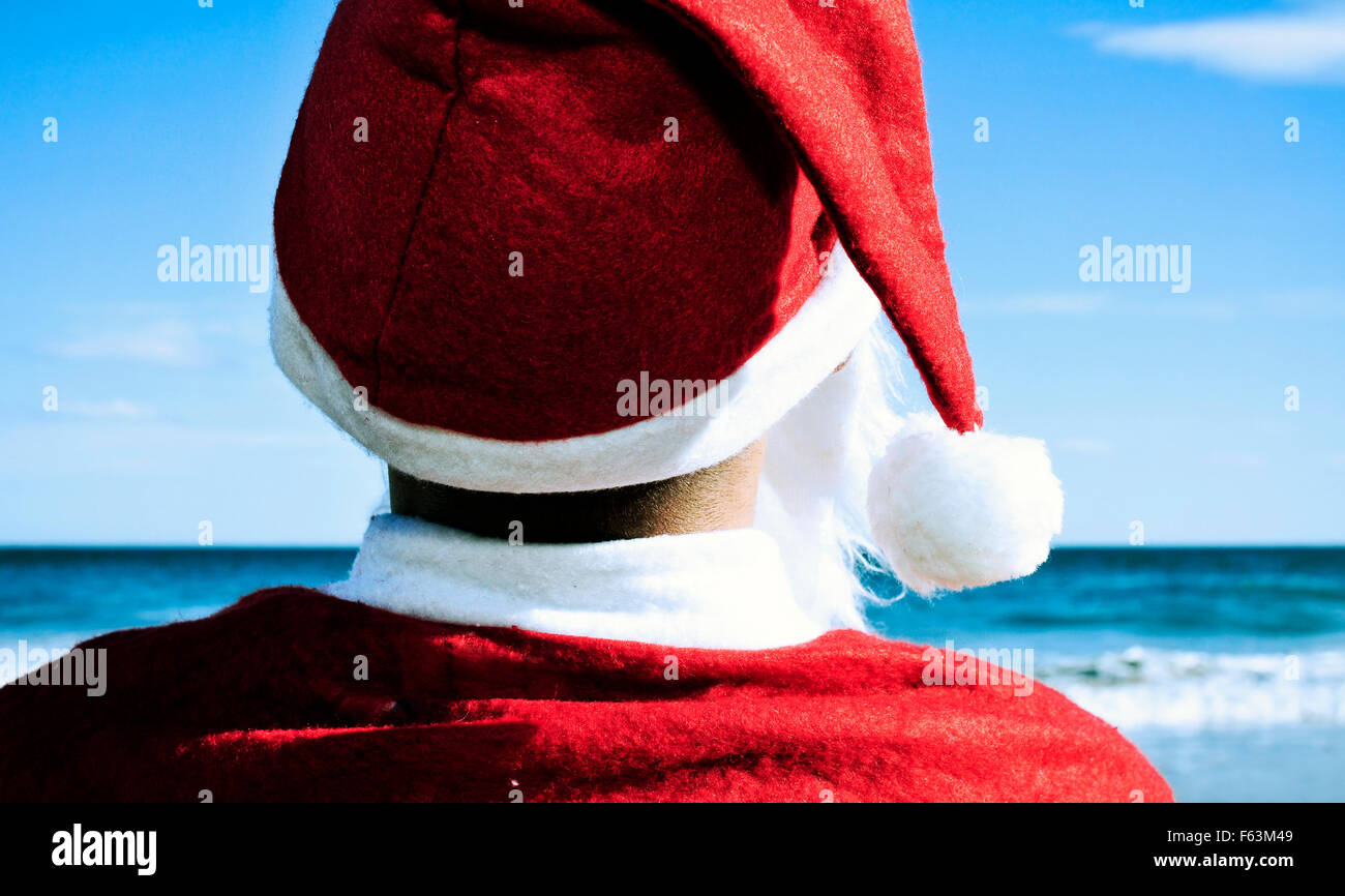 santa claus seen from behind on the beach facing the horizon Stock ...