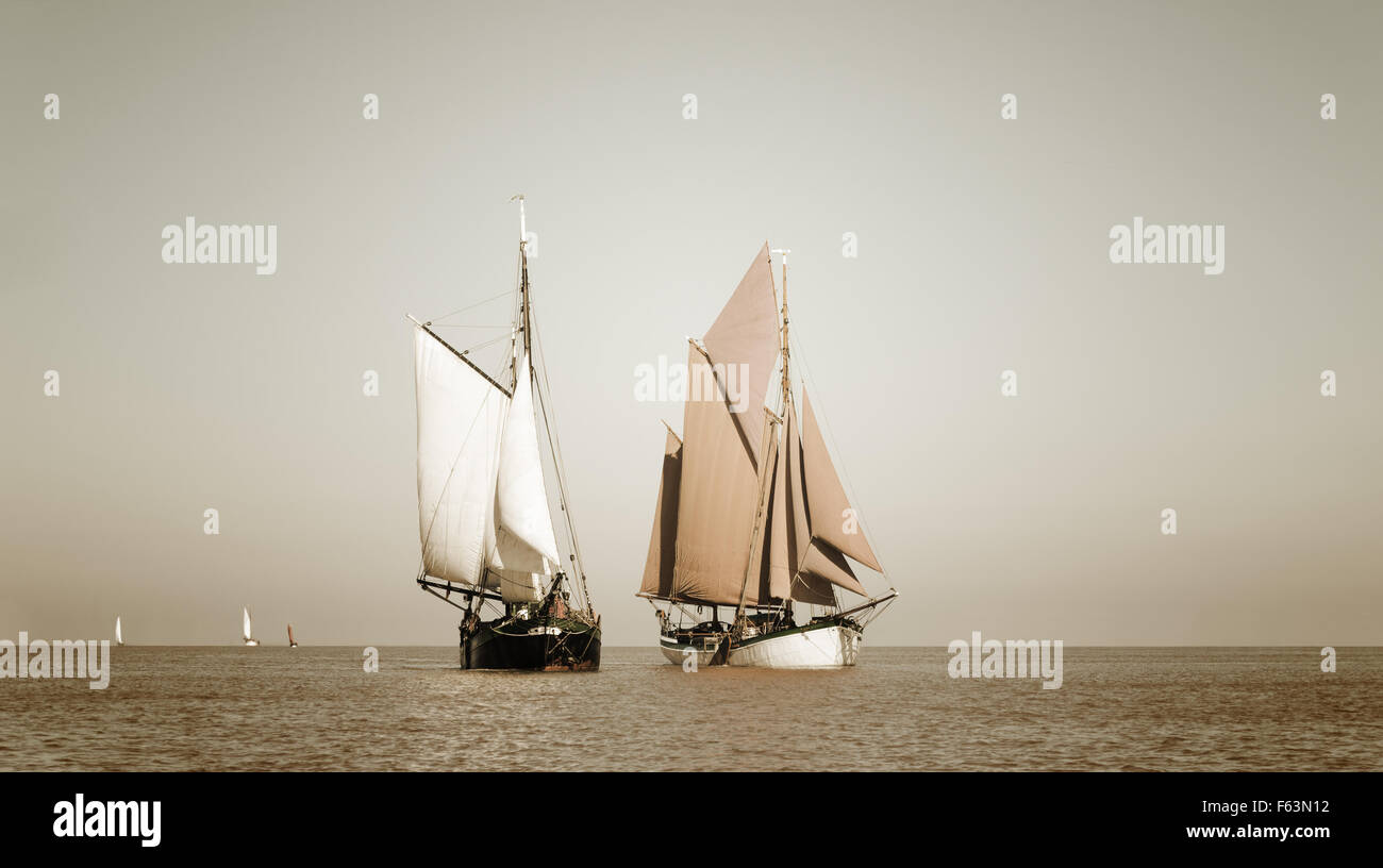 Traditional sailing ships, sailing on the ocean. Sepia toned to give a ...