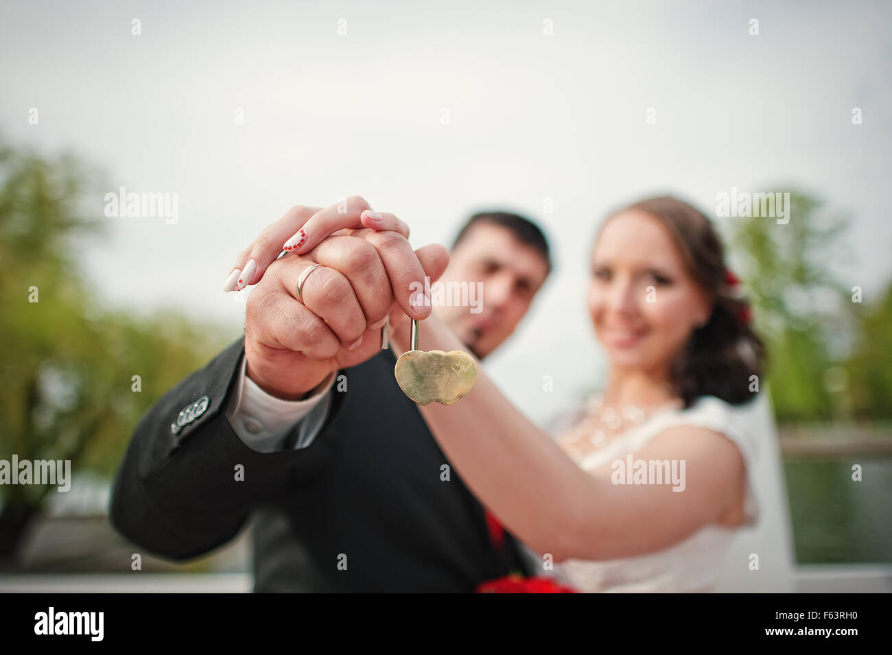 hands wedding couple with lock and rings Stock Photo - Alamy