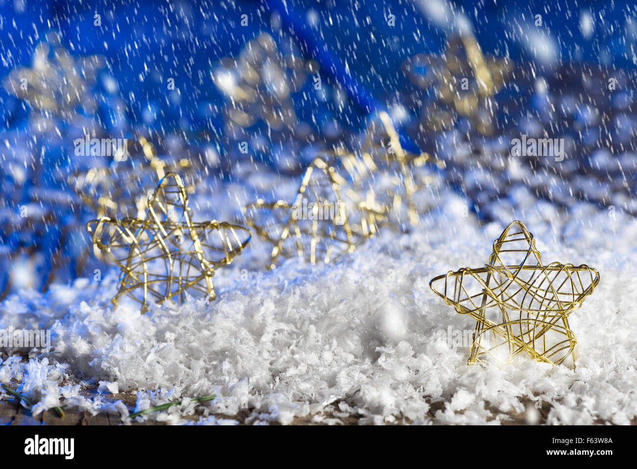 Christmas stars in the snow on the blue background Stock Photo - Alamy