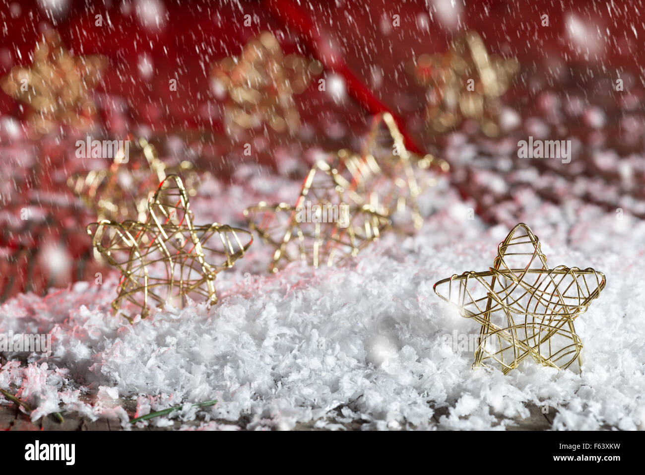 Christmas stars in the snow on the red background Stock Photo - Alamy
