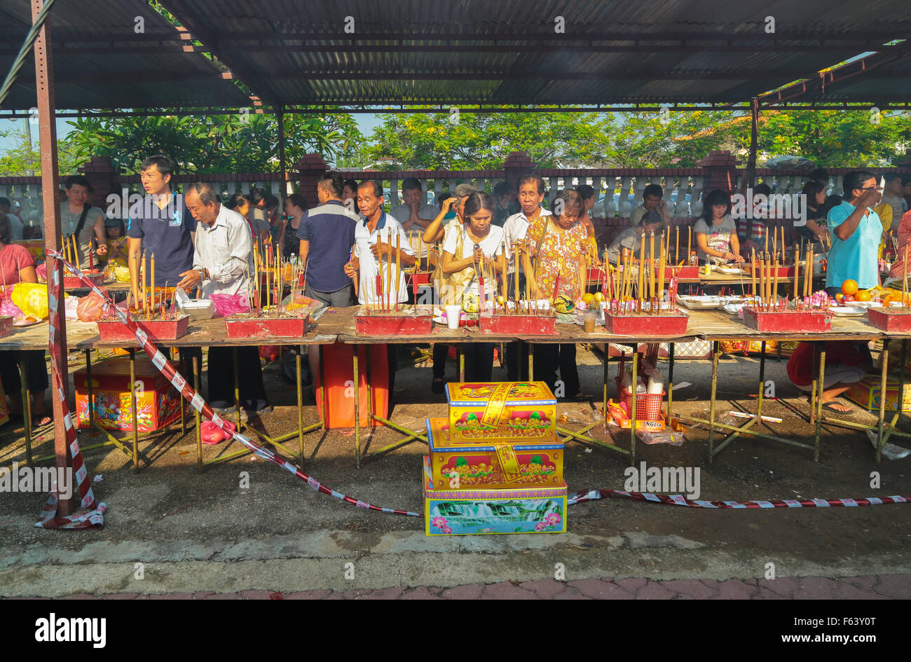 Chinese family preparing ancestor offering at Kwong Tong cemetary ...