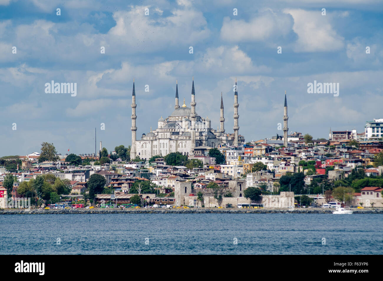 Historic mosque towers over the waterfront area of Istanbul on a cloudy ...