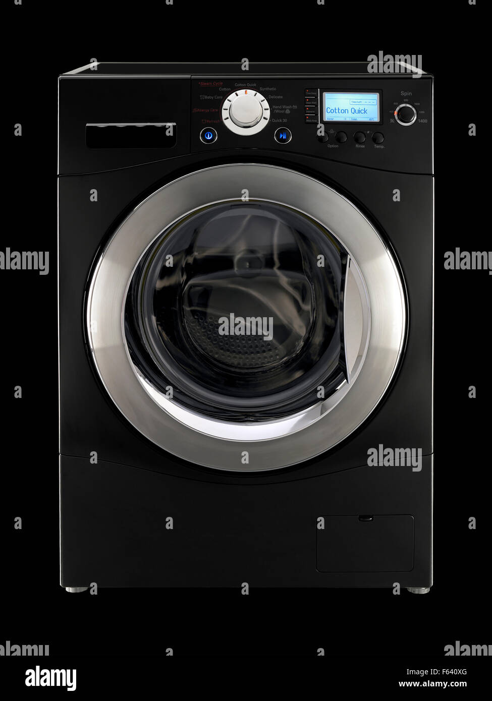 Washing machine black frontal view low key against black background ...