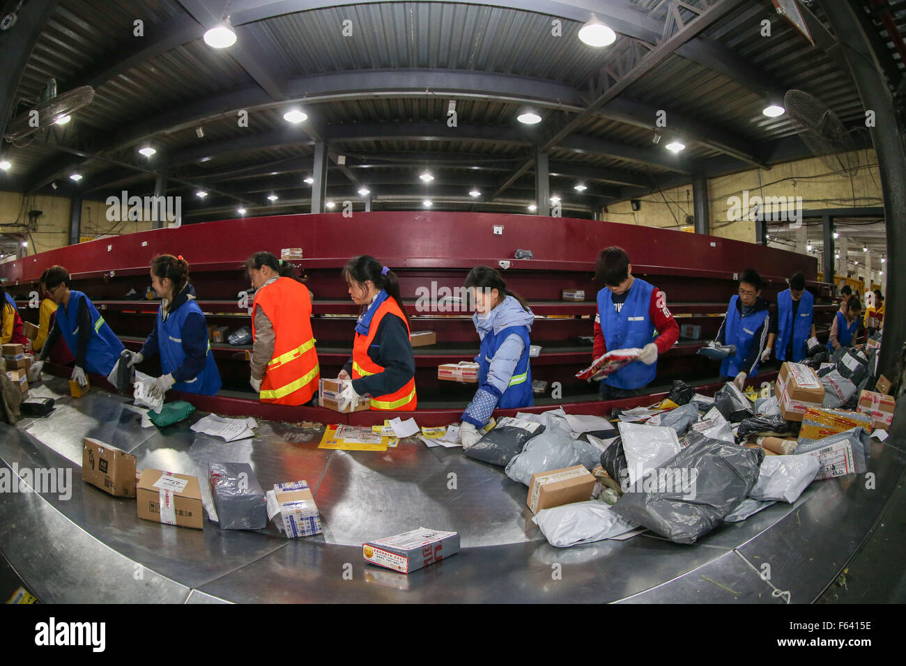 Shanghai, China. 11th Nov, 2015. Workers sort out packages at a sorting ...