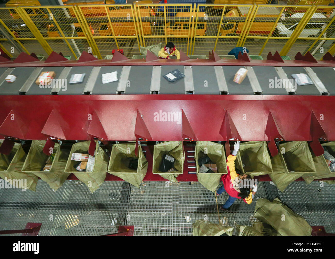 Shanghai, China. 11th Nov, 2015. Workers sort out packages at a sorting ...