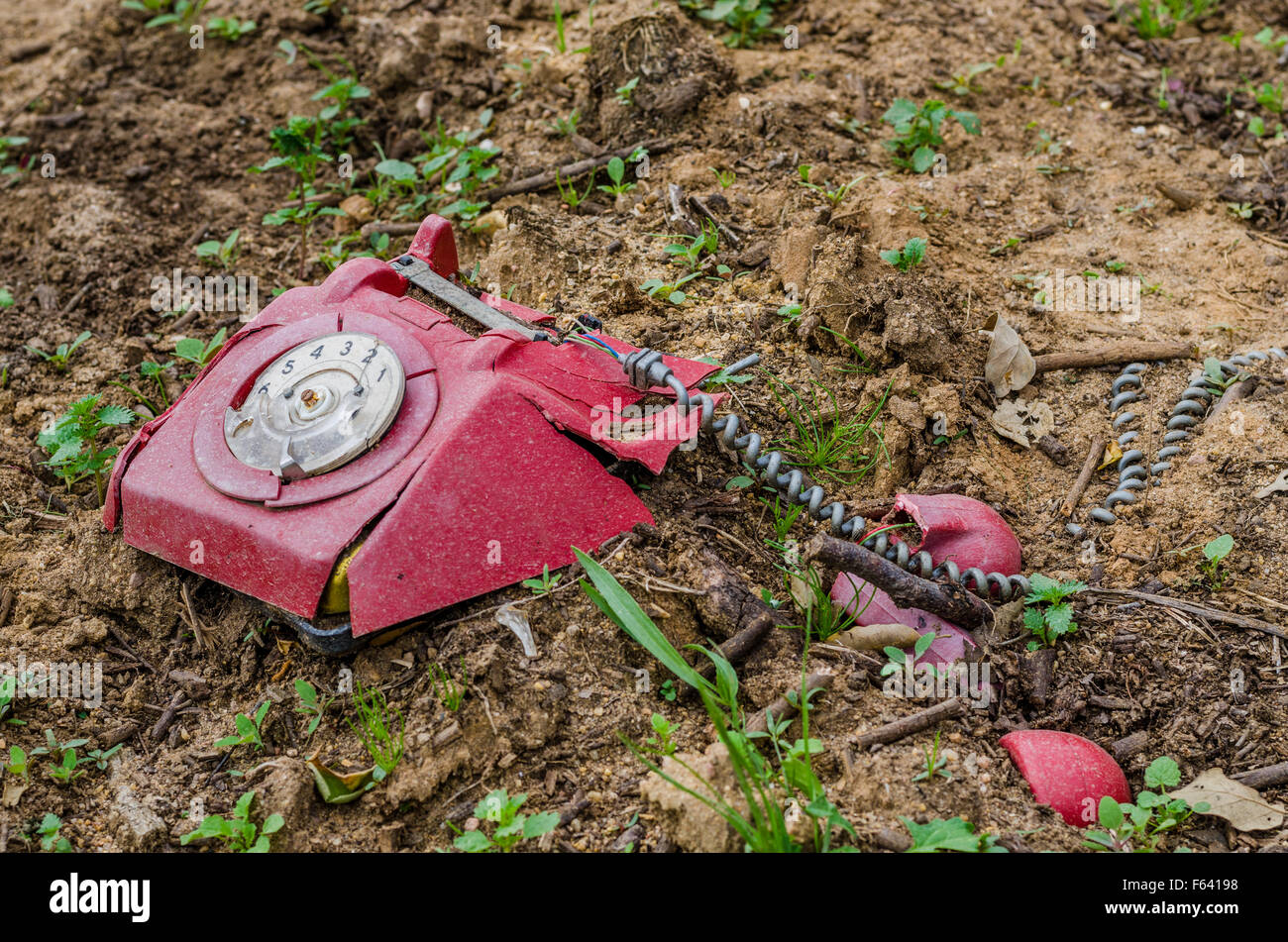 Broken old style telephone on the ground Stock Photo - Alamy