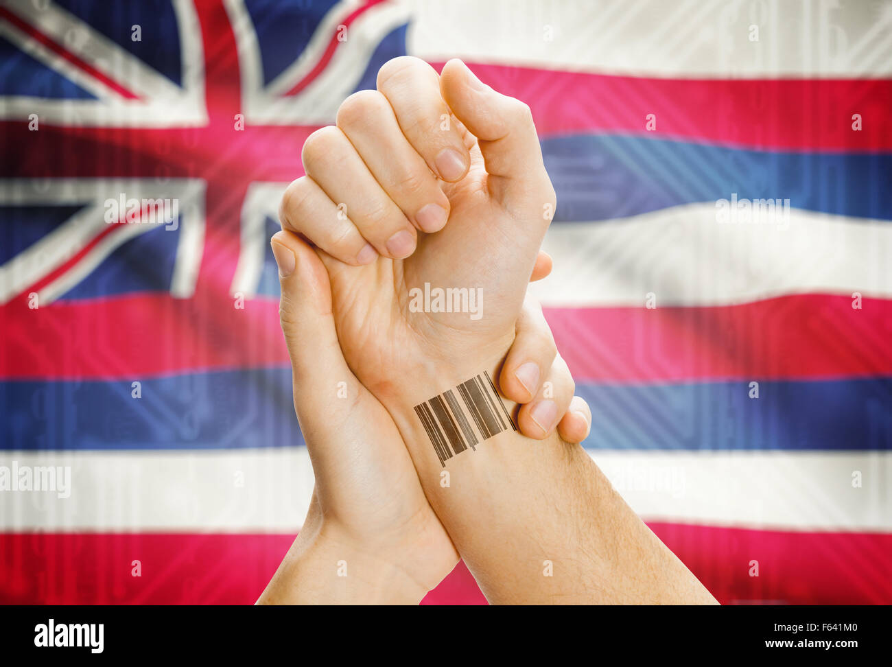 Barcode ID number tatoo on wrist and USA statesl flag on background ...