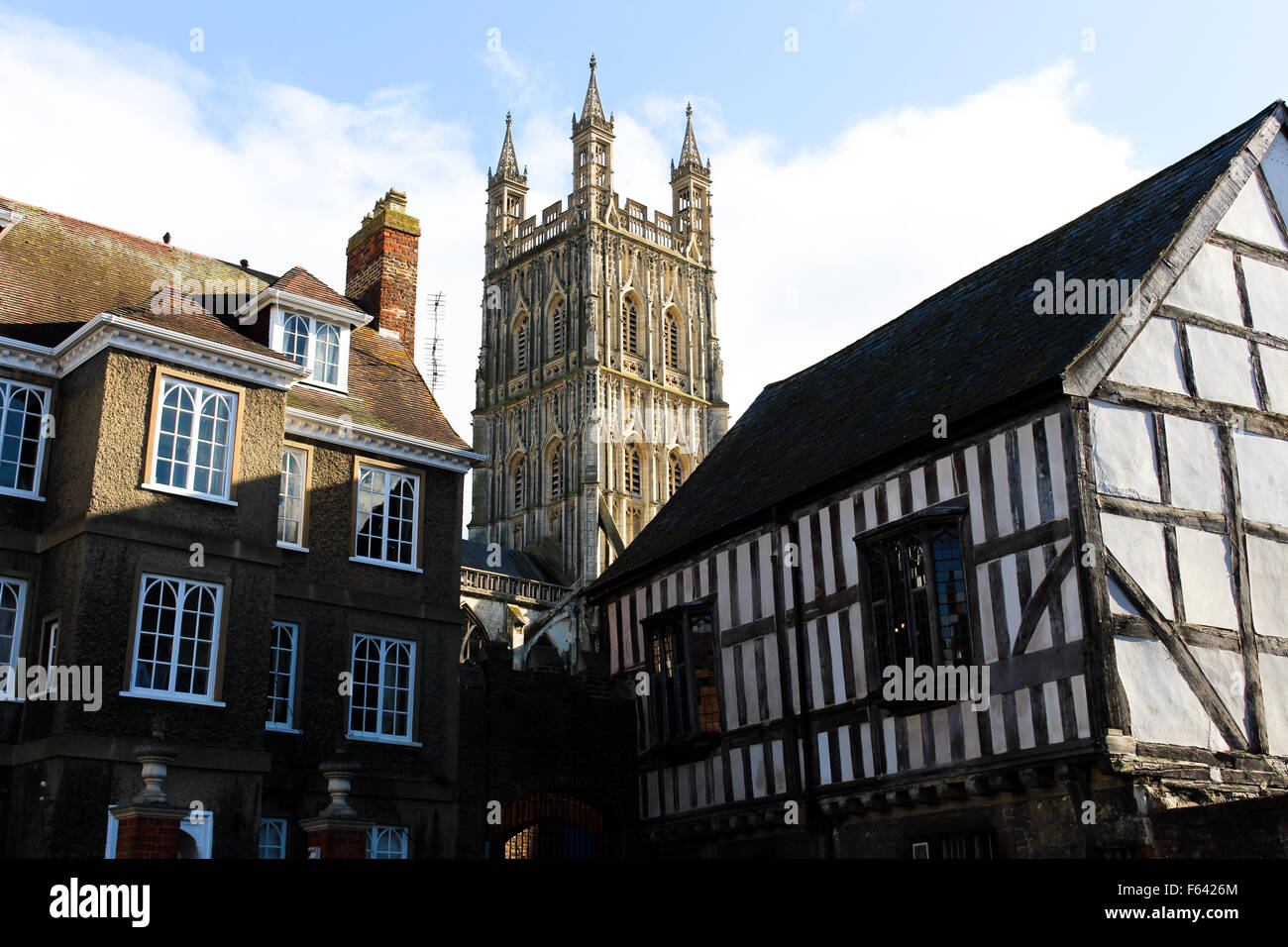 Gloucester Cathedral seen between an old tudor building and a victorian ...