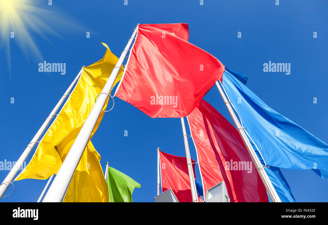 Colorful flags fluttering on the blue sky background Stock Photo - Alamy