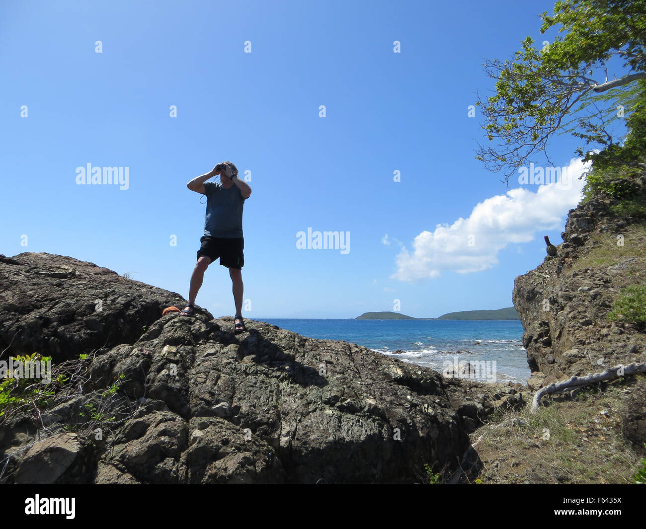 Man searching with binoculars Stock Photo - Alamy