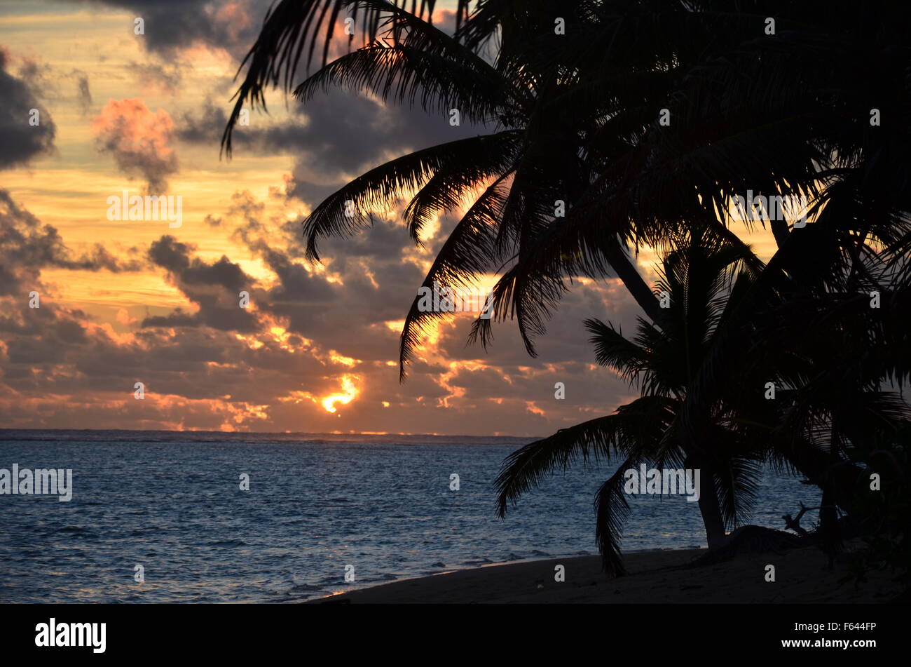Sun setting over the Cook Islands Stock Photo - Alamy