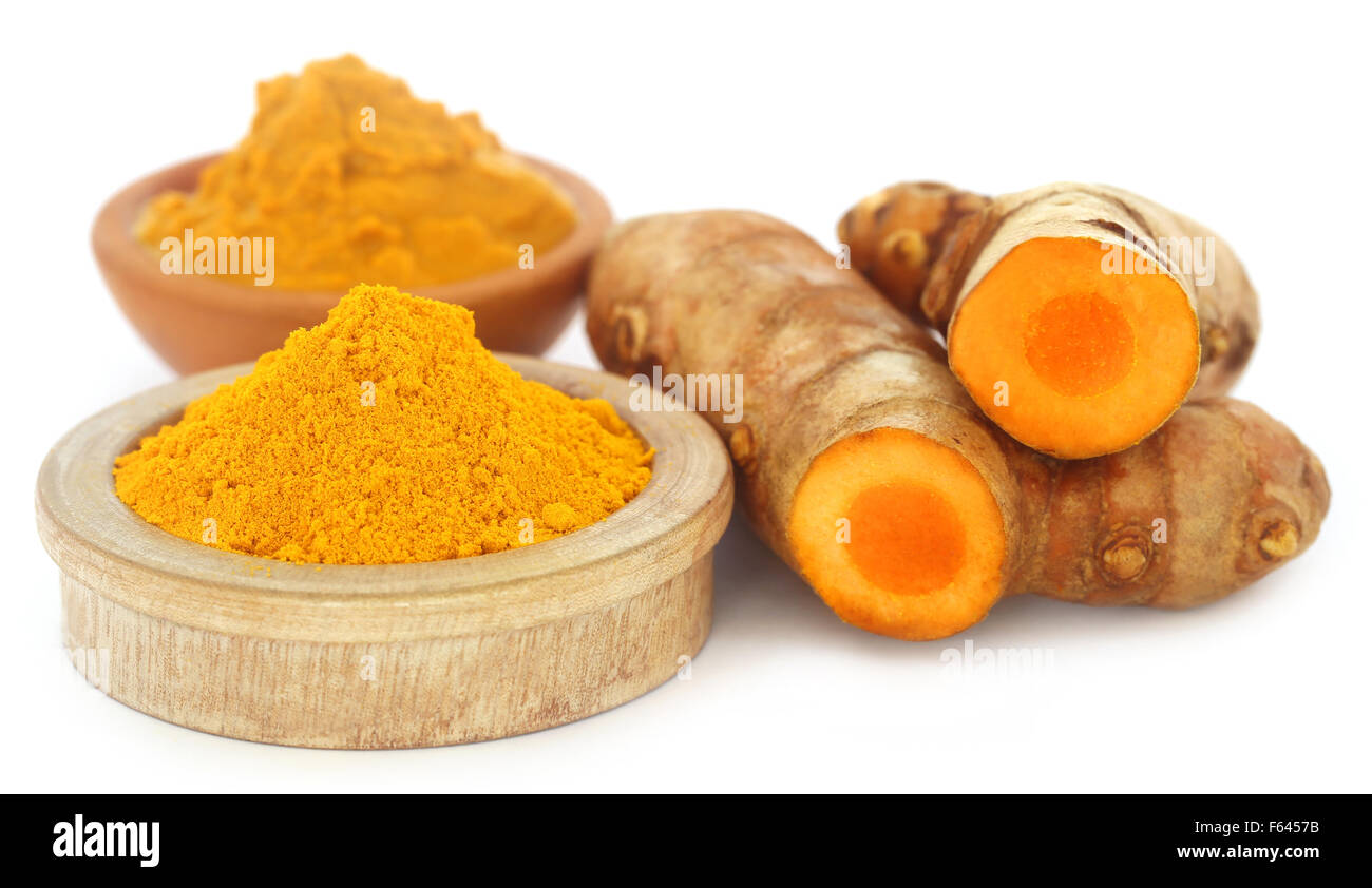Ground and mashed turmeric with whole ones Stock Photo - Alamy