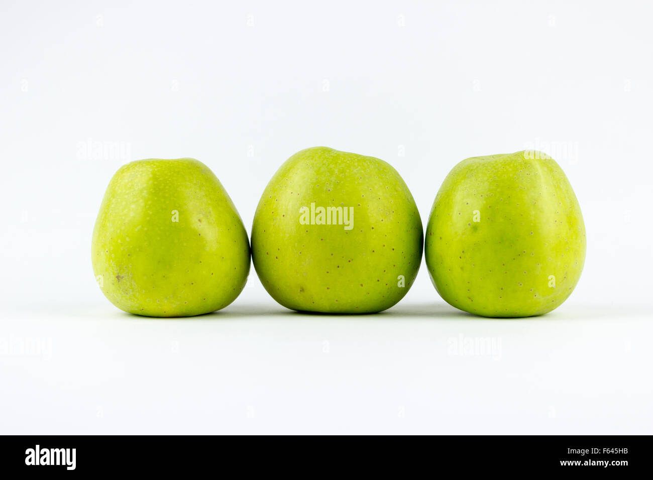 Three green apples, isolated on a white background Stock Photo - Alamy