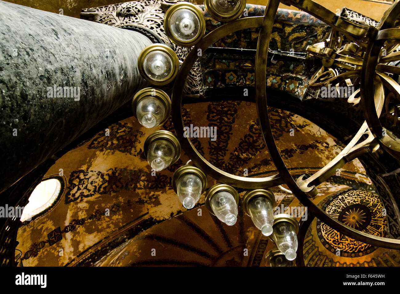 Ornate chandelier and intricate ceiling design seen from below in a ...