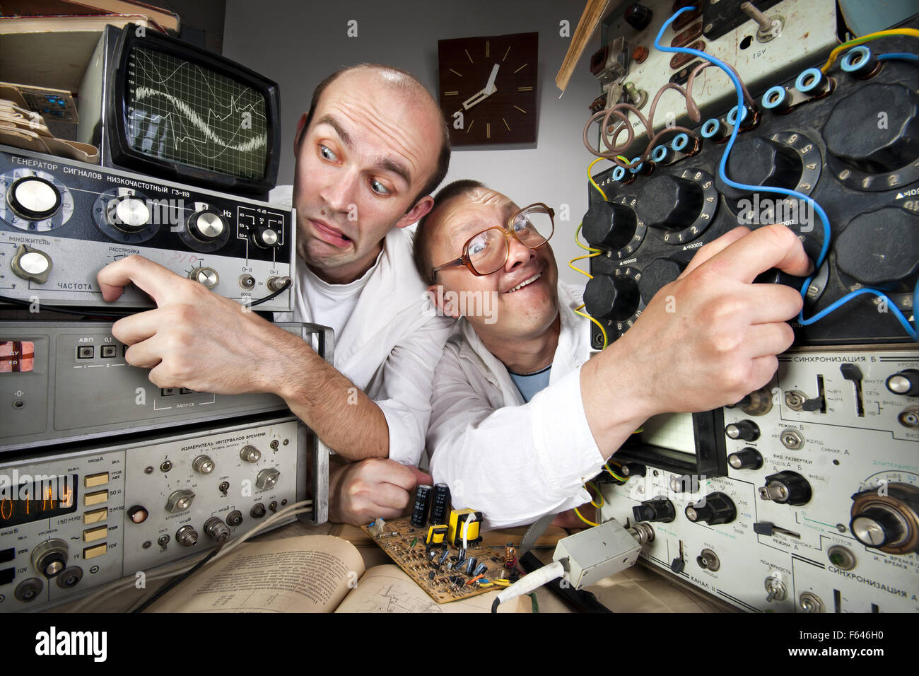 Two funny nerd scientists working at vintage technological laboratory ...