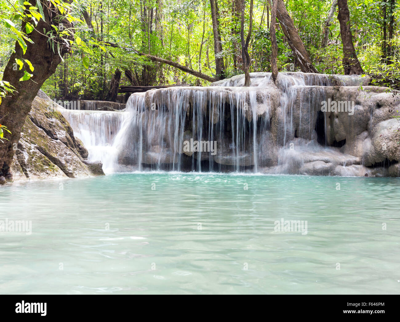 Tropical waterfall Erawan and forest at background Stock Photo - Alamy