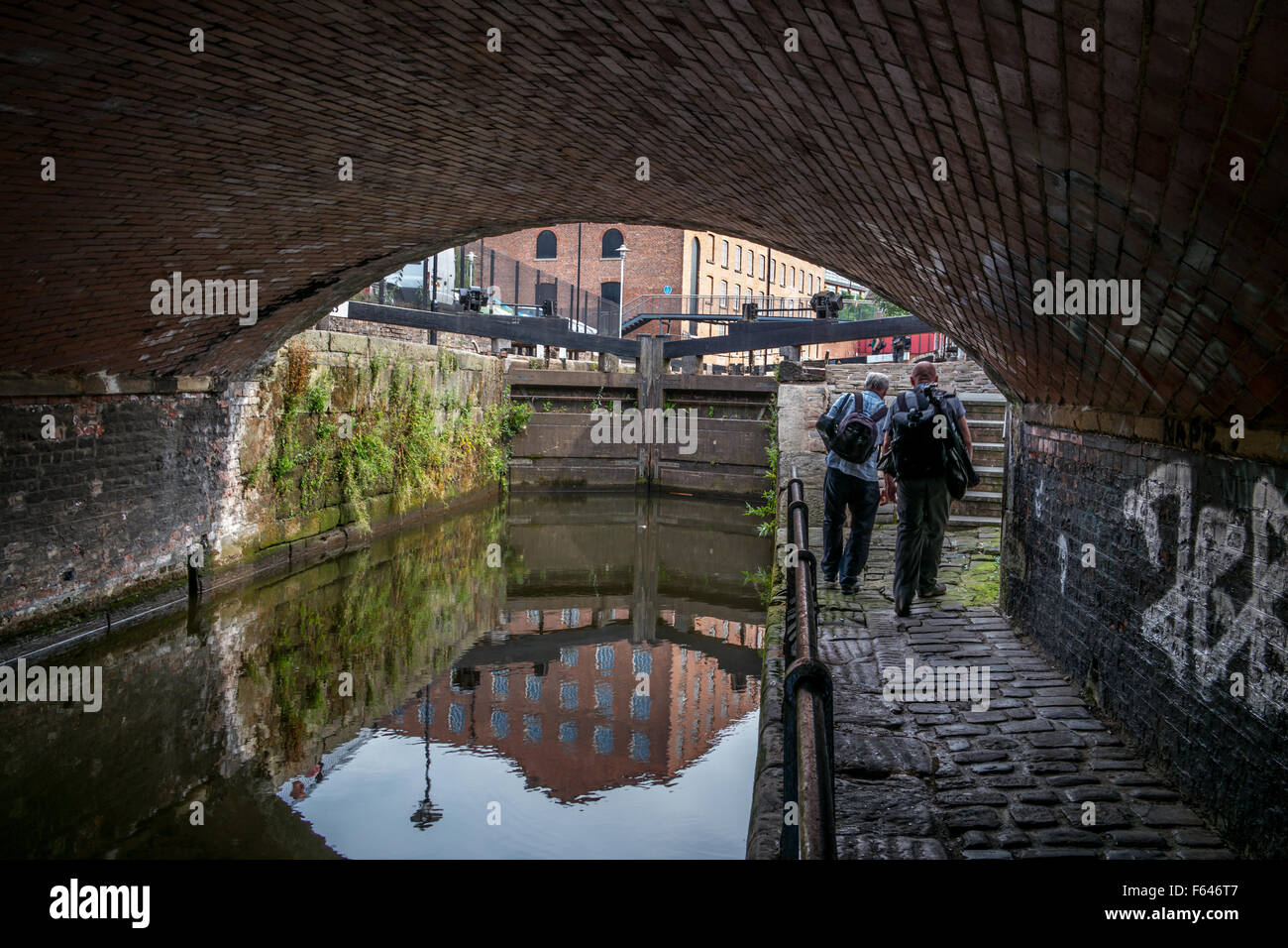 Two men walking along the towpath away from the camera along the ...
