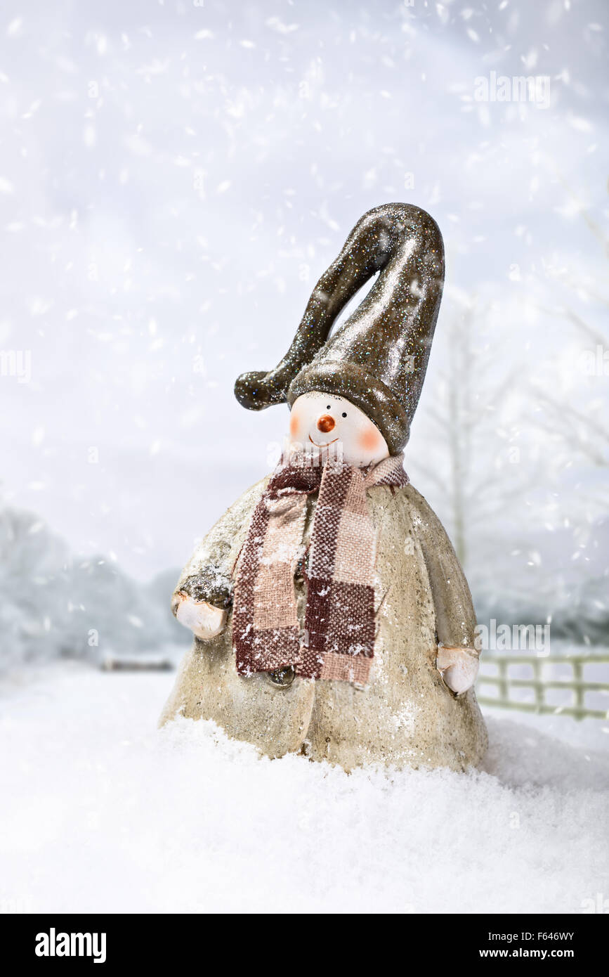 Snowman in country lane with snow falling Stock Photo - Alamy