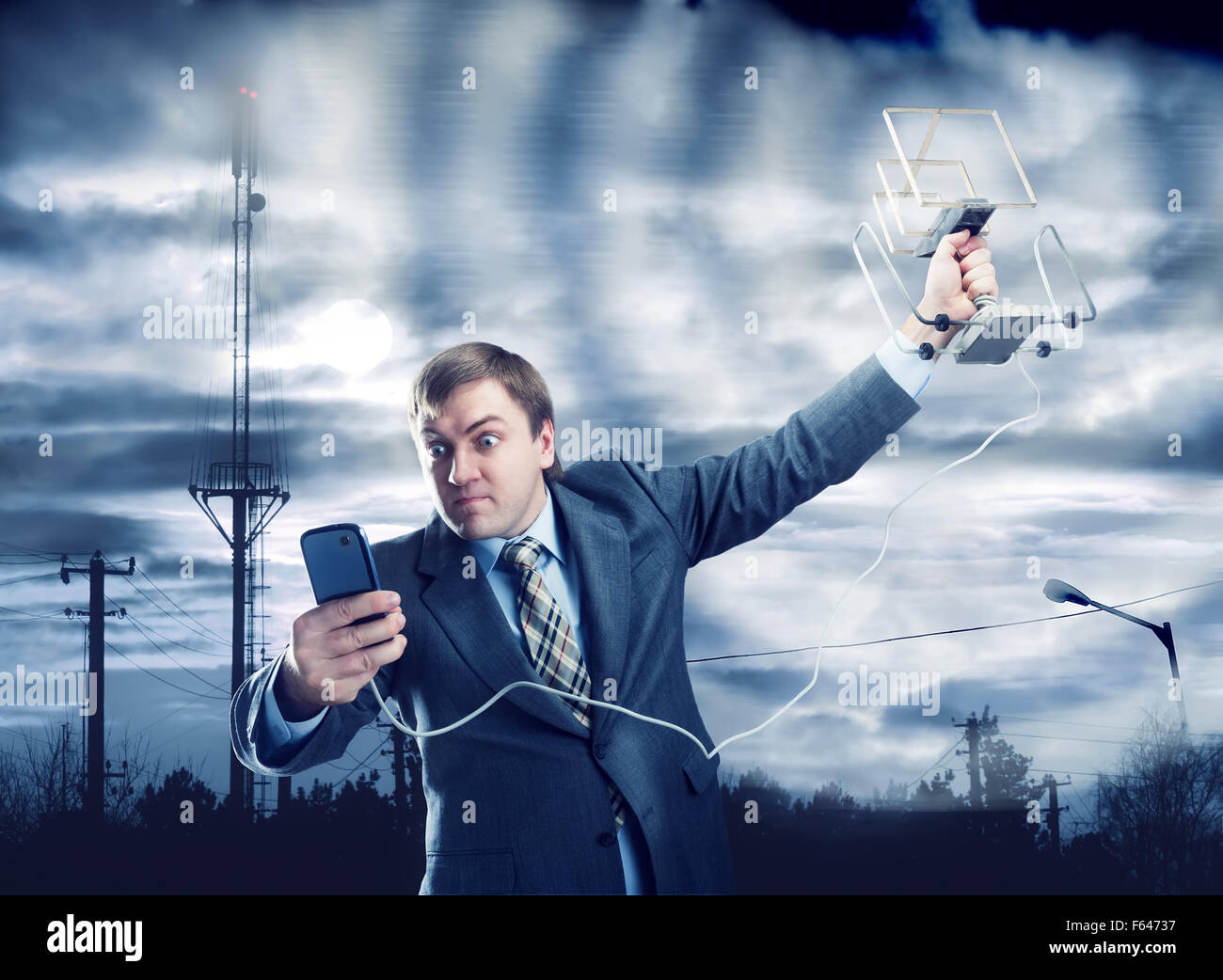 Businessman trying to find signal in storm Stock Photo - Alamy