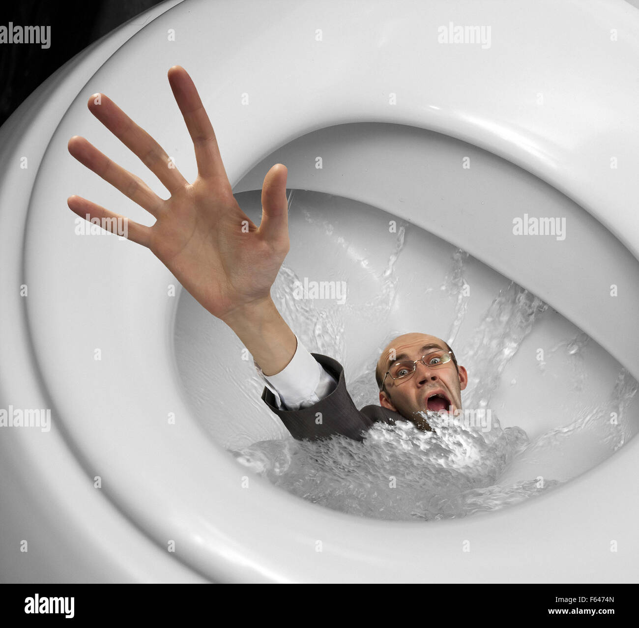 Businessman sinking in toilet bowl. Close-up view Stock Photo - Alamy