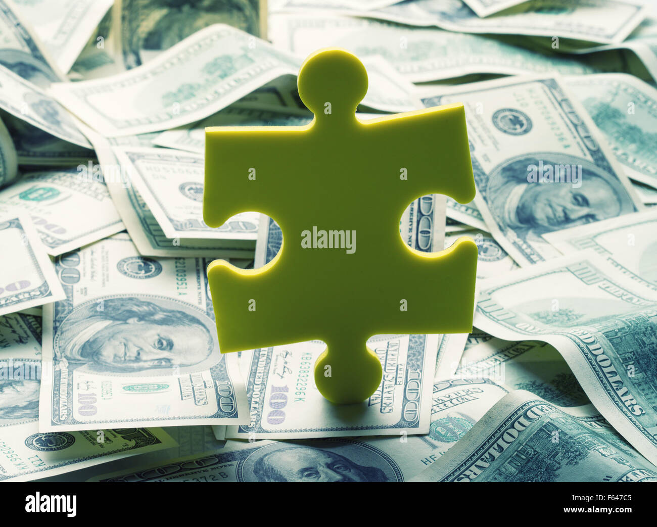 Jigsaw puzzle on heap of $100 dollar bills Stock Photo - Alamy