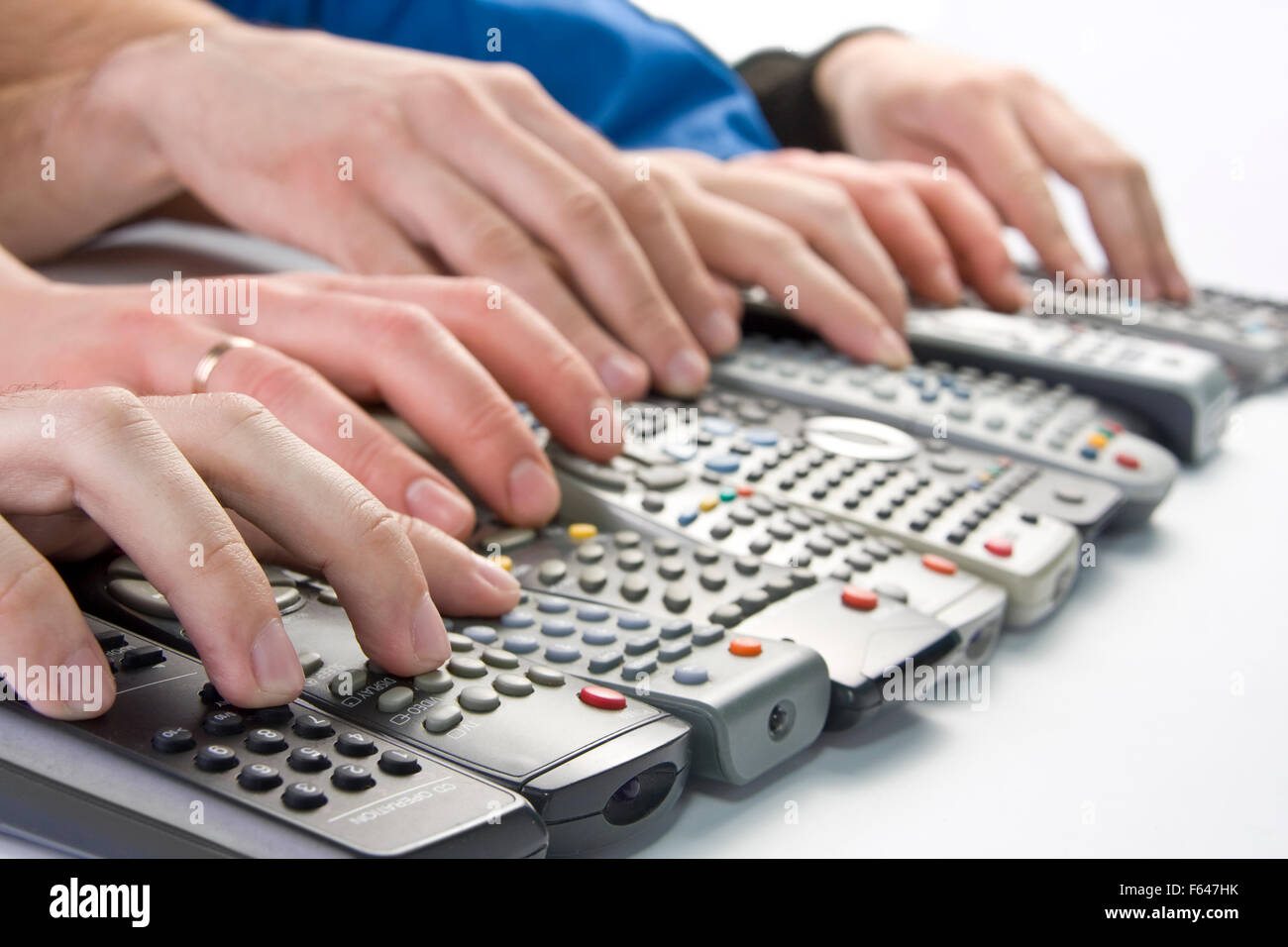 Remote controlers with many hands Stock Photo - Alamy