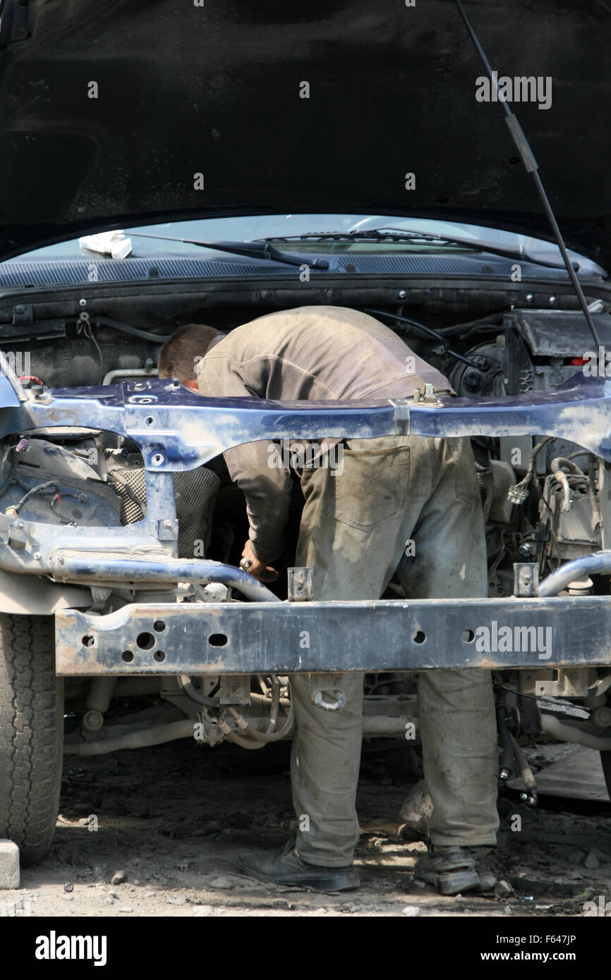 Auto service. Mechanic working inside the car Stock Photo - Alamy