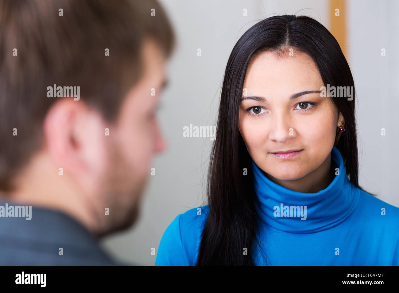 Couple talking. Face of woman and man from back image Stock Photo - Alamy