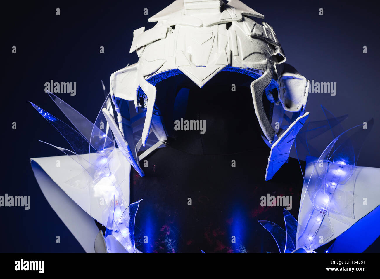 woman robot, white suit with transparent plastic and LED lights on the ...