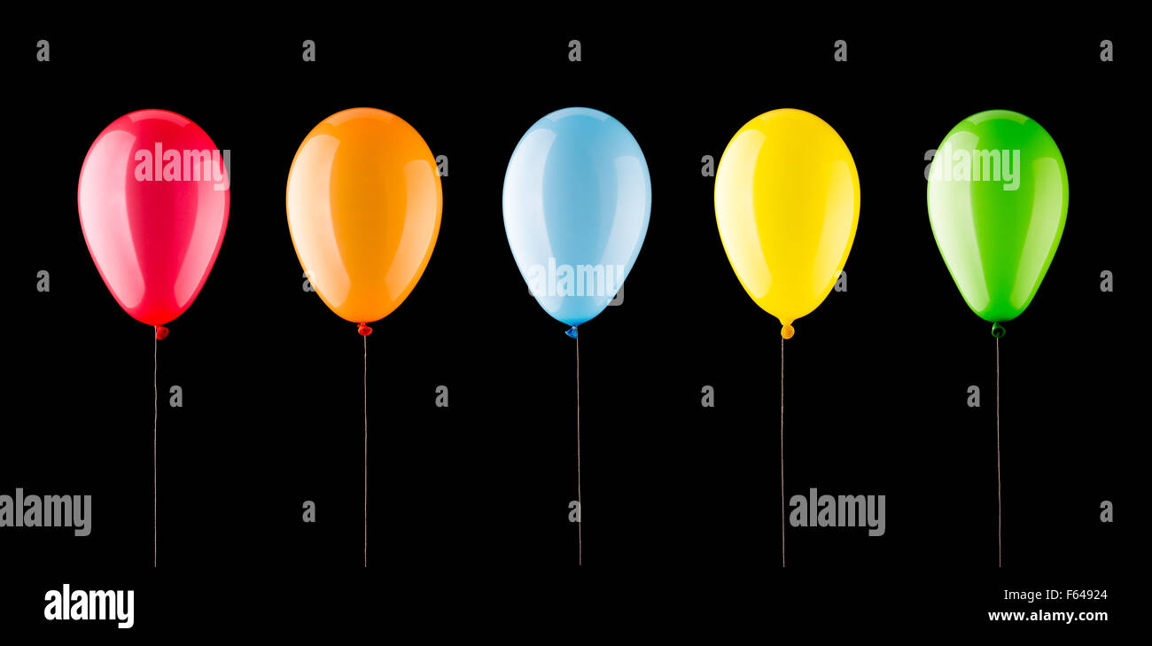 Five colorful balloons in a row isolated on black Stock Photo - Alamy