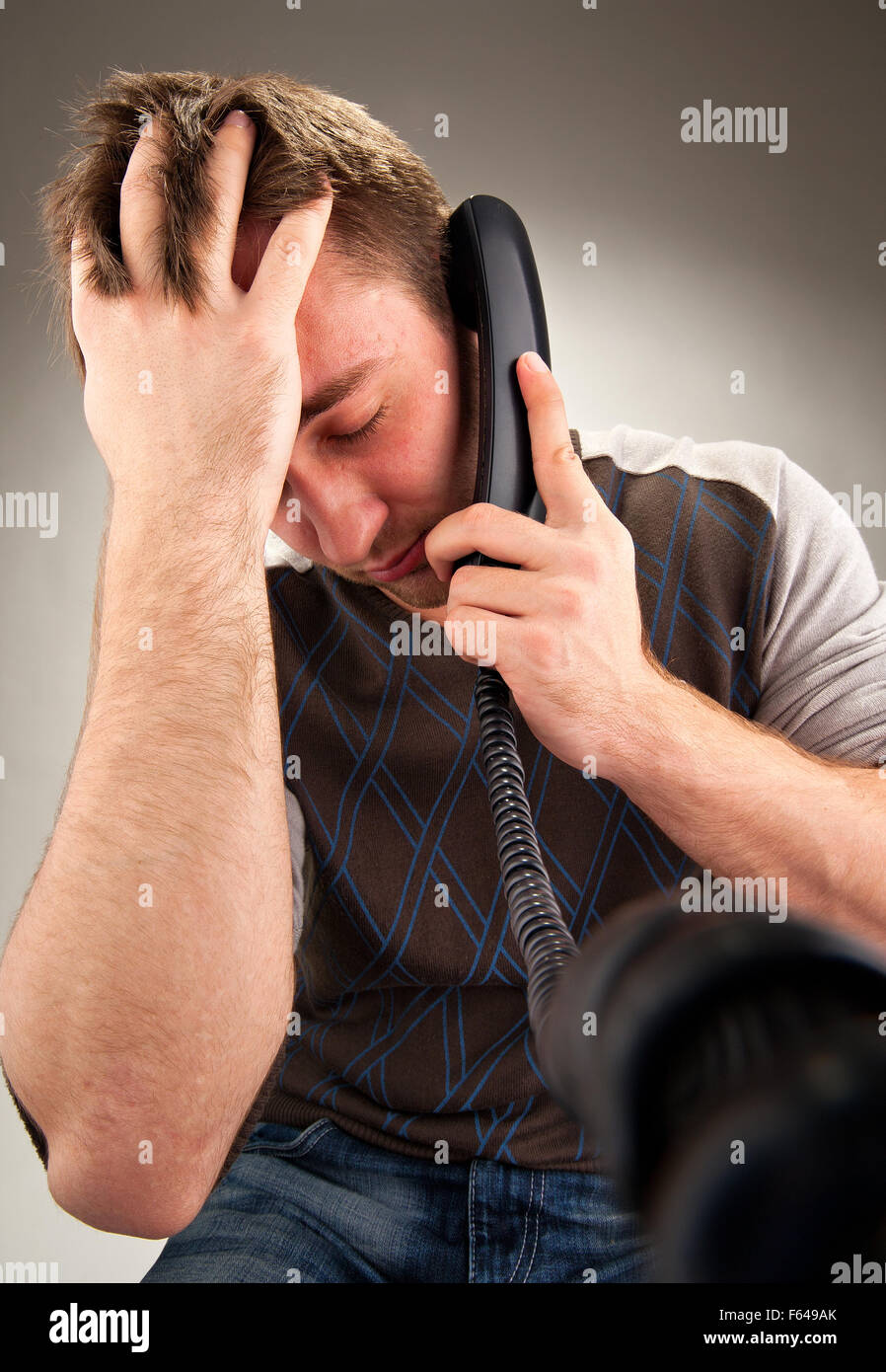 Portrait of tired office manager talking by phone Stock Photo - Alamy