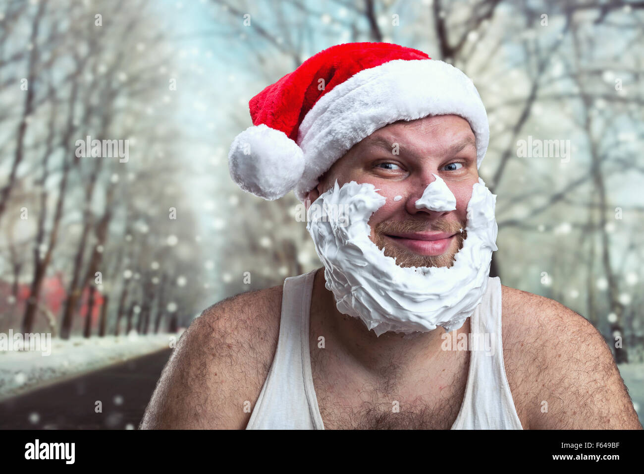 Smiling man in Santa Claus hat with shaving foam on his face Stock ...
