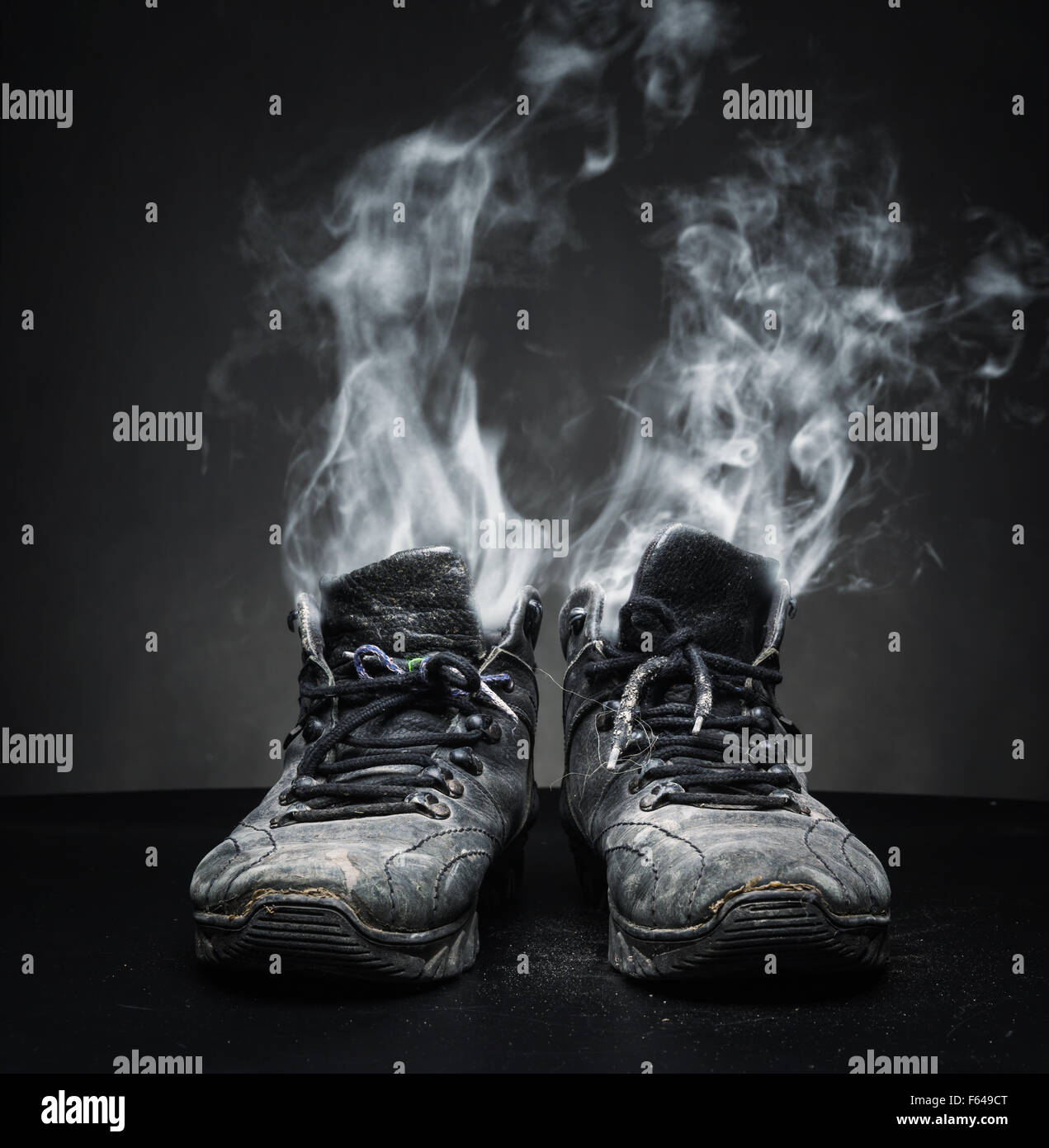 Old black work shoes from which the smoke proceeds Stock Photo - Alamy