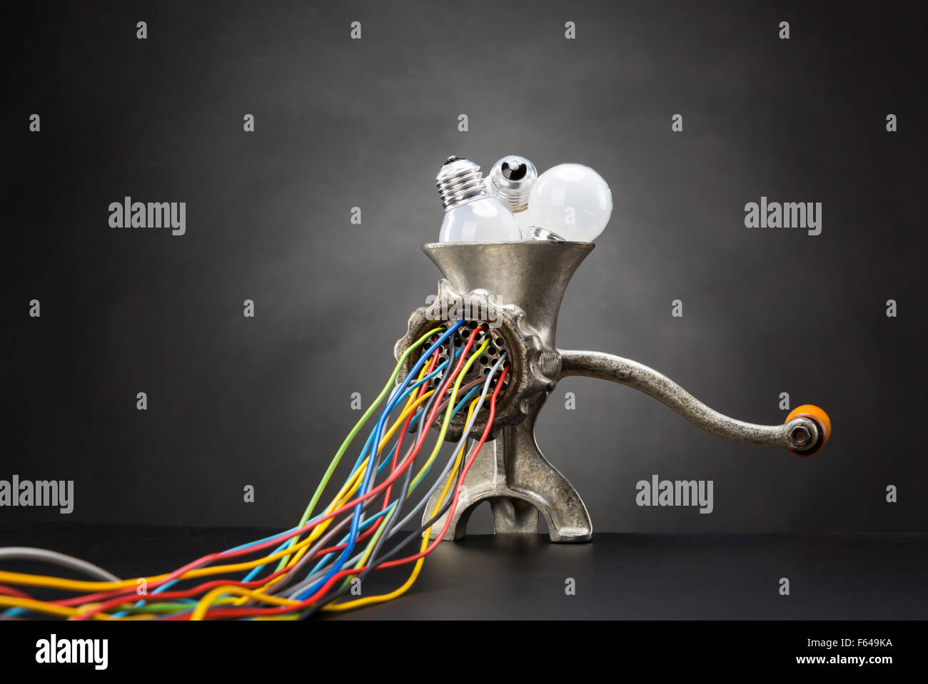 Mincing machine is grinding up light bulbs to cables Stock Photo - Alamy