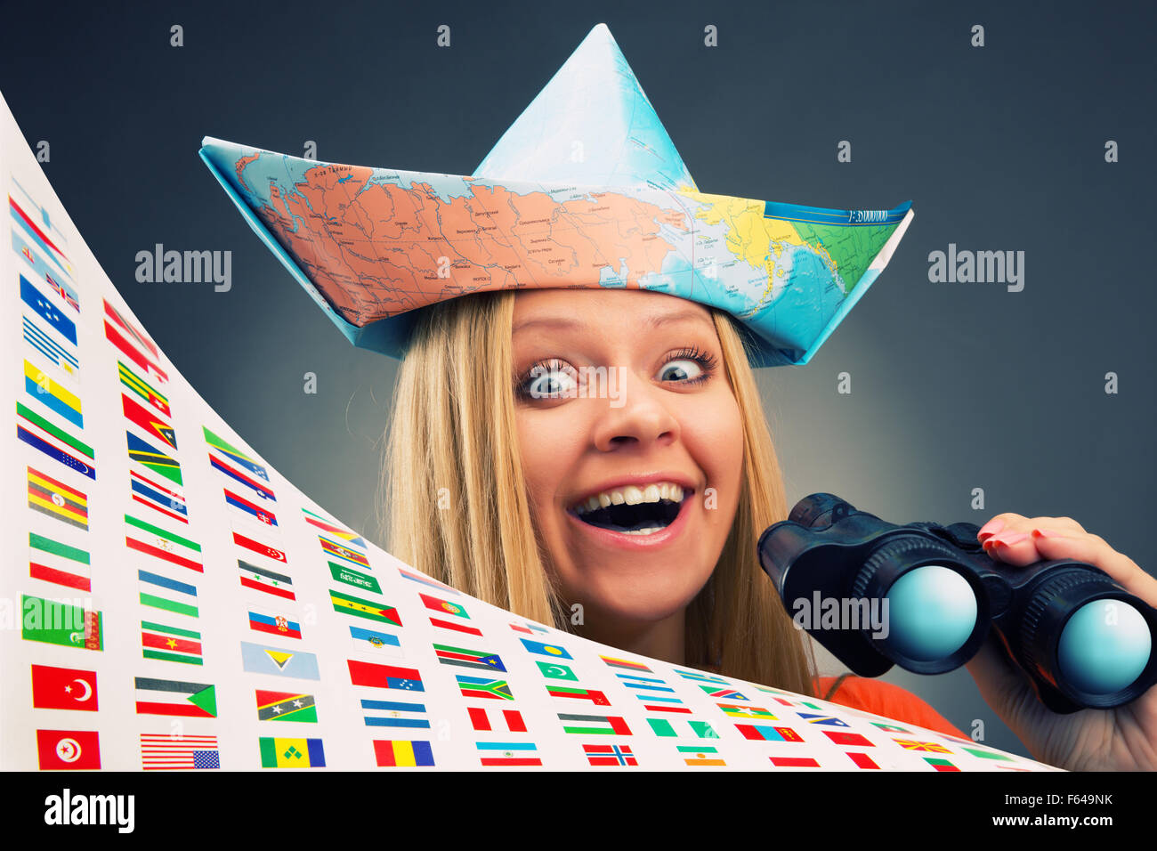 Excited traveler girl discovering world flags with binoculars Stock ...