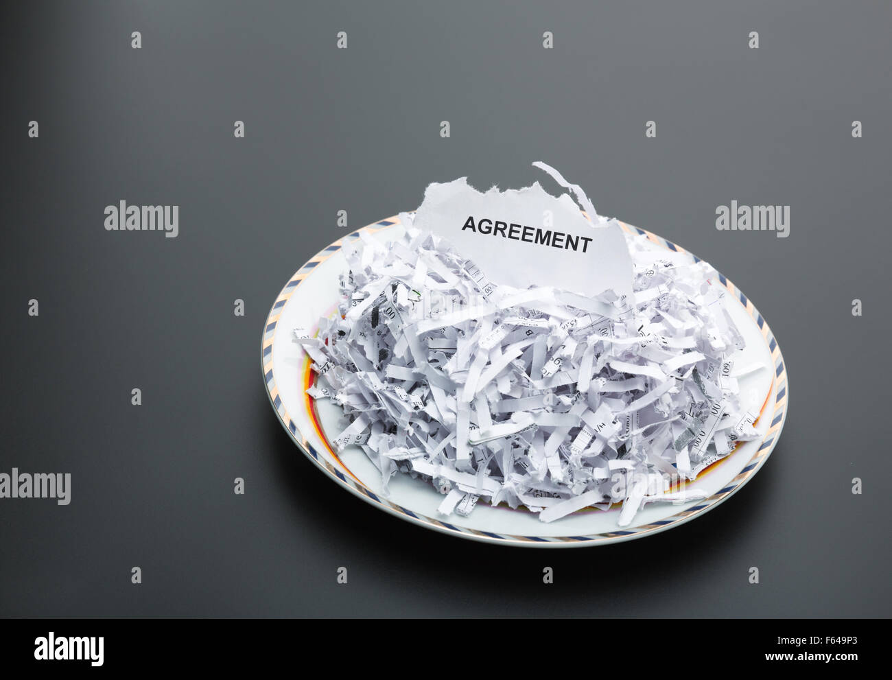 Plate of heap of white shredded papers and paper with agreement Stock ...