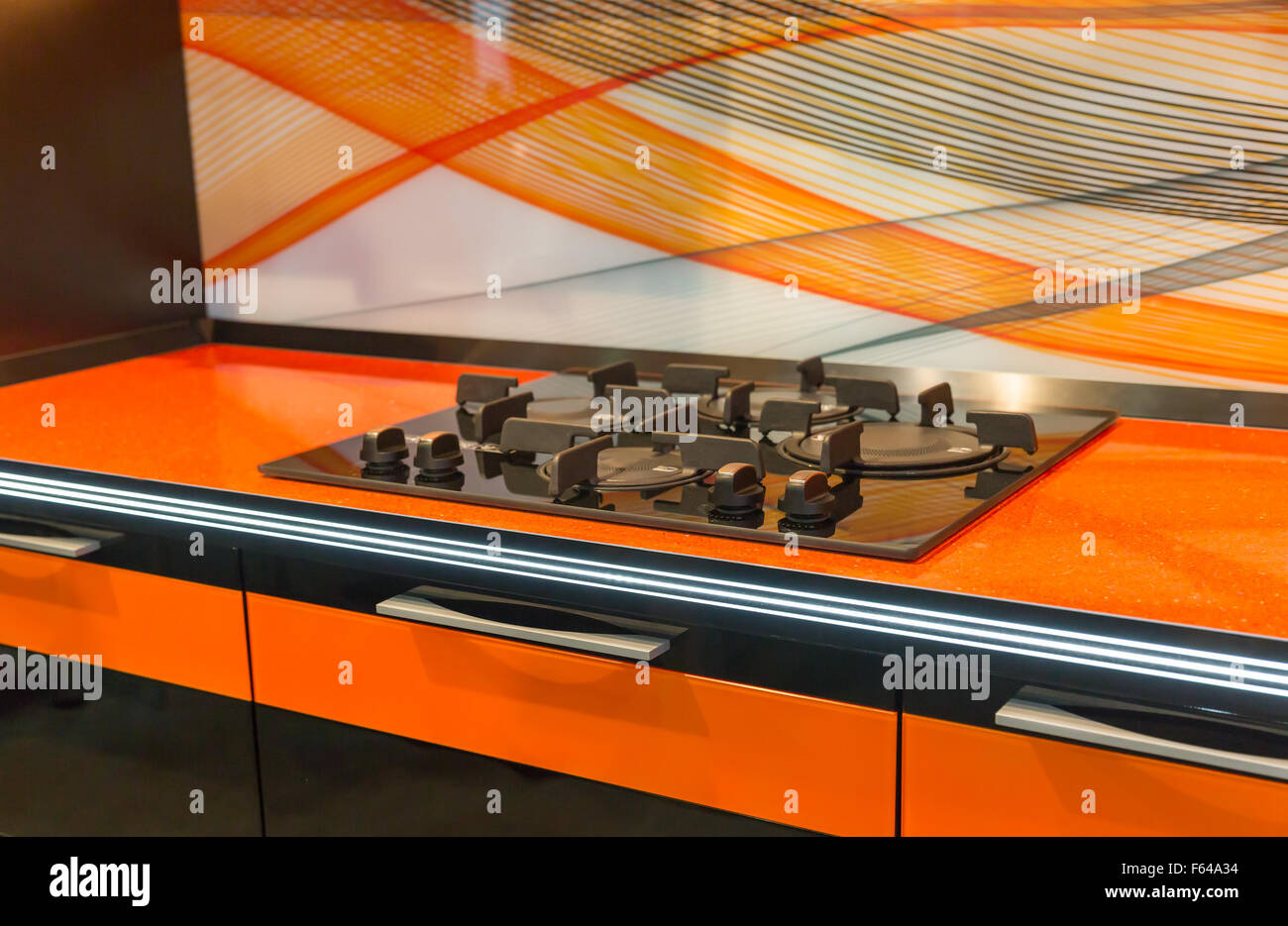 Close up shot of stove for modern orange kitchen Stock Photo - Alamy