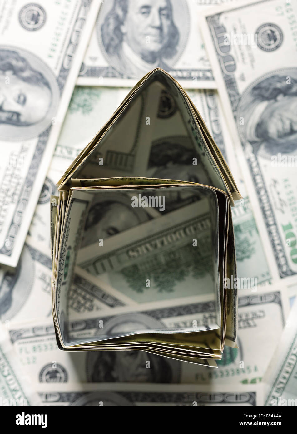 $100 bills make a house symbol Stock Photo - Alamy