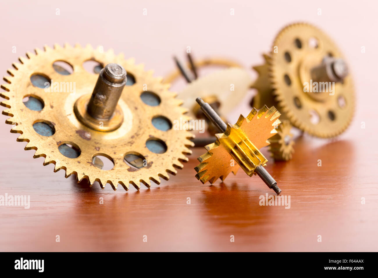 Various clock gears on the wooden table Stock Photo - Alamy
