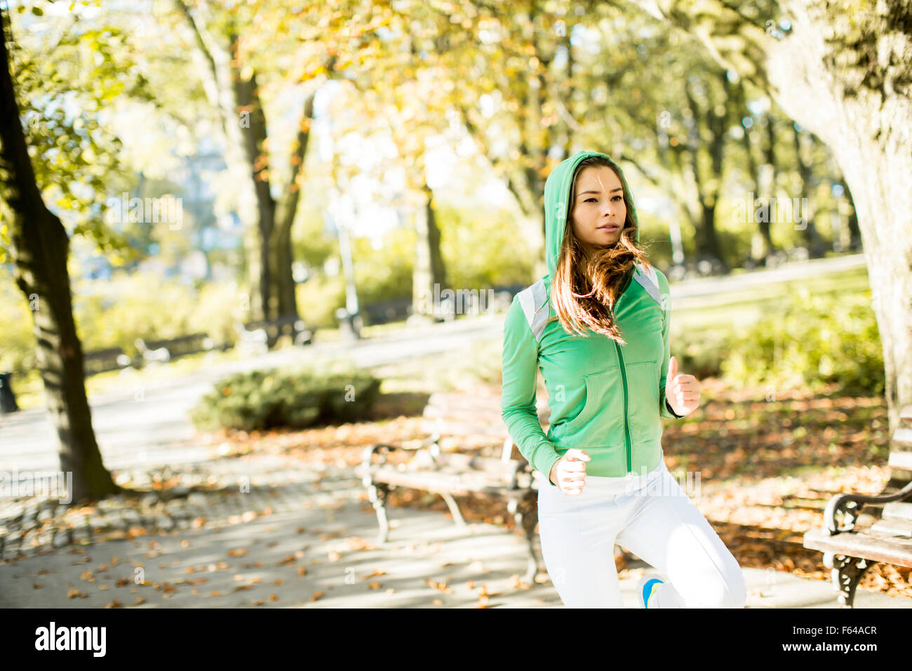 Young woman running in the park Stock Photo - Alamy