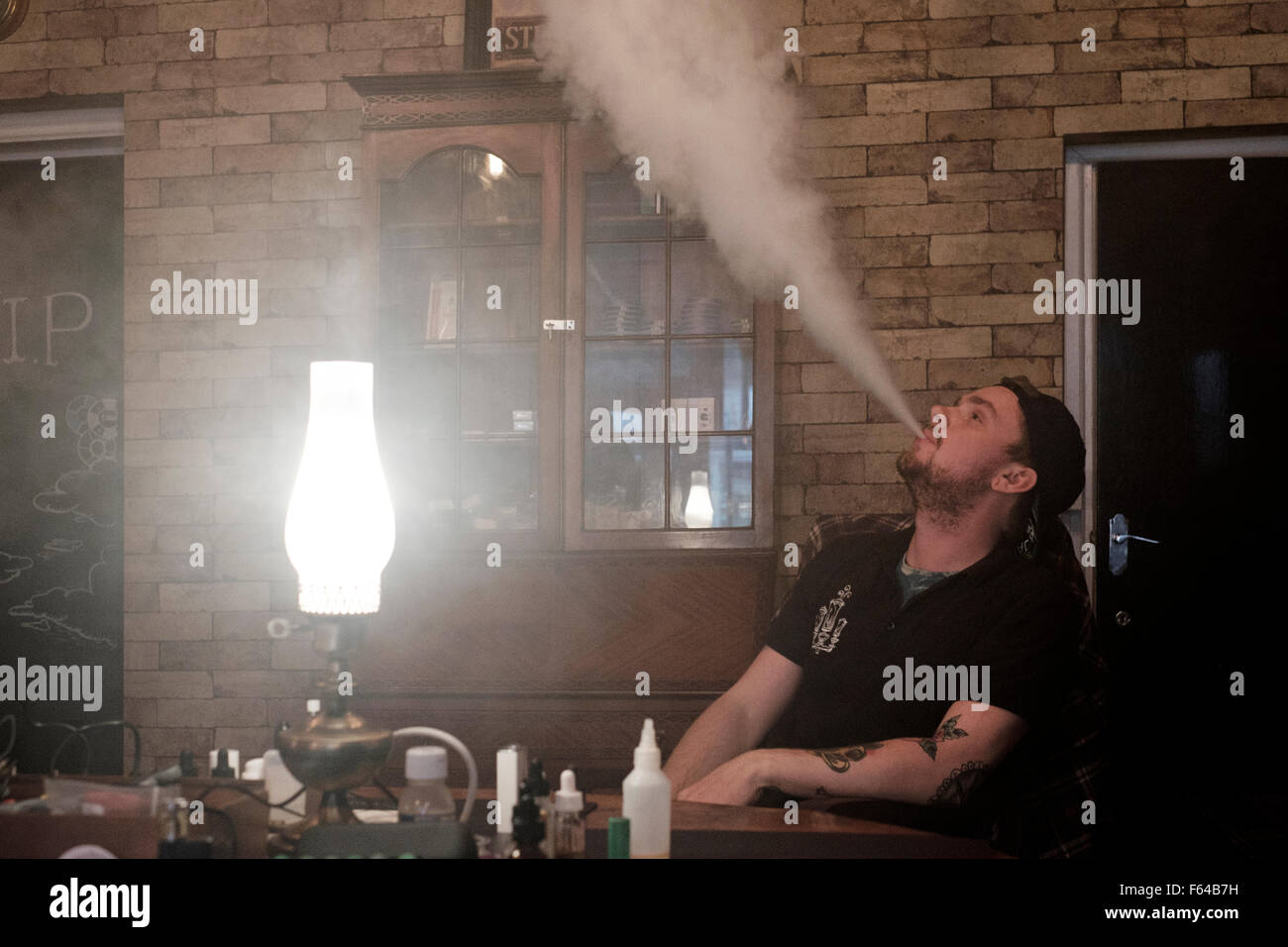 man blows billowing clouds of vapour while vaping using an electronic ...