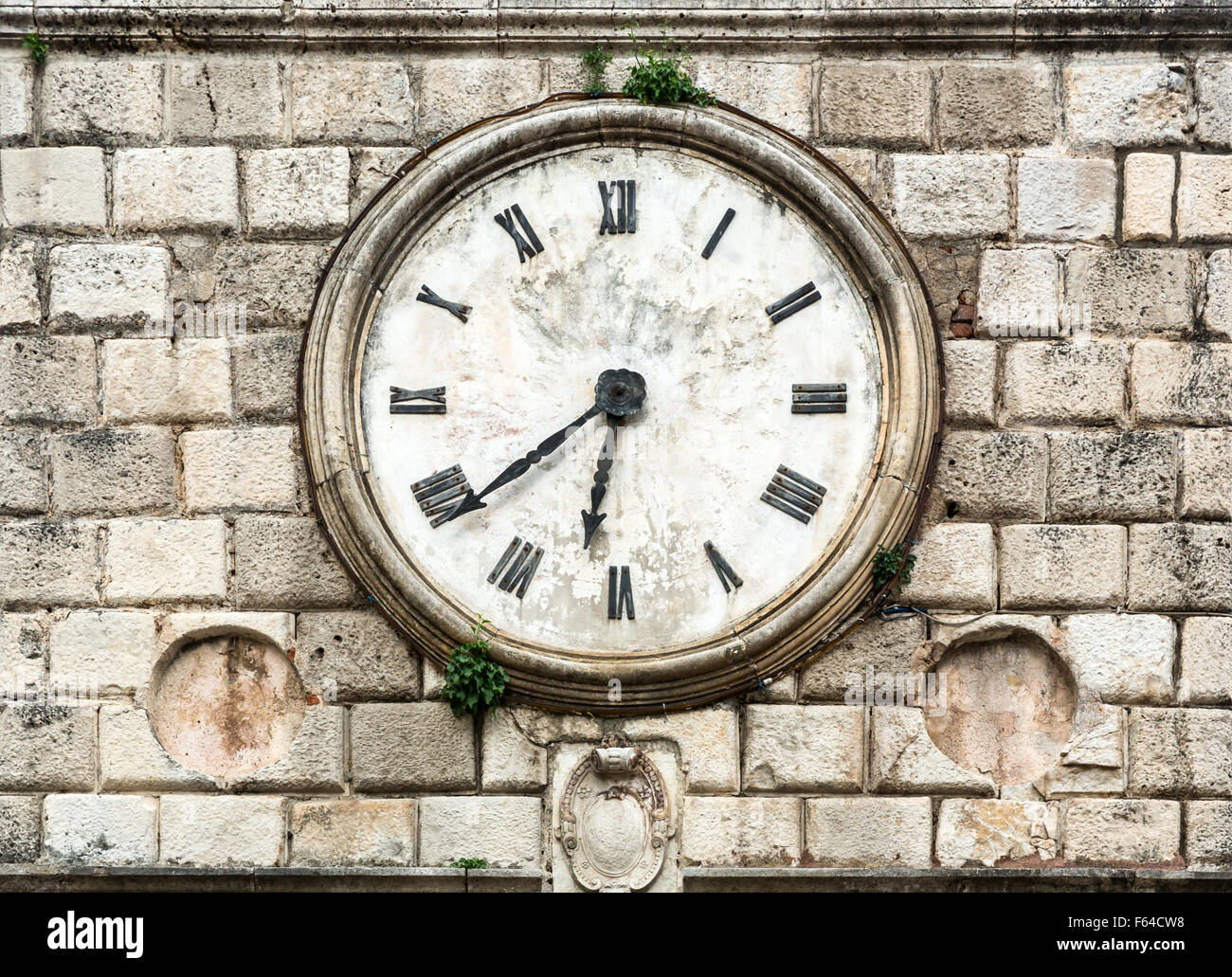 Antique clock on a building. Ancient brick wall Stock Photo - Alamy