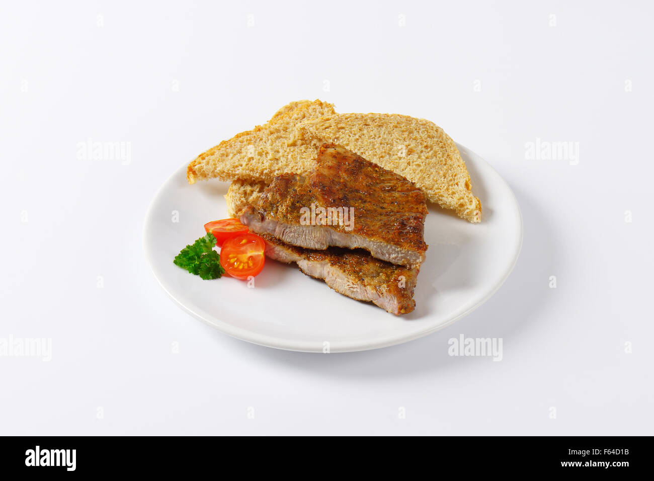 two slices of roasted pork meat with toast bread on white plate Stock ...
