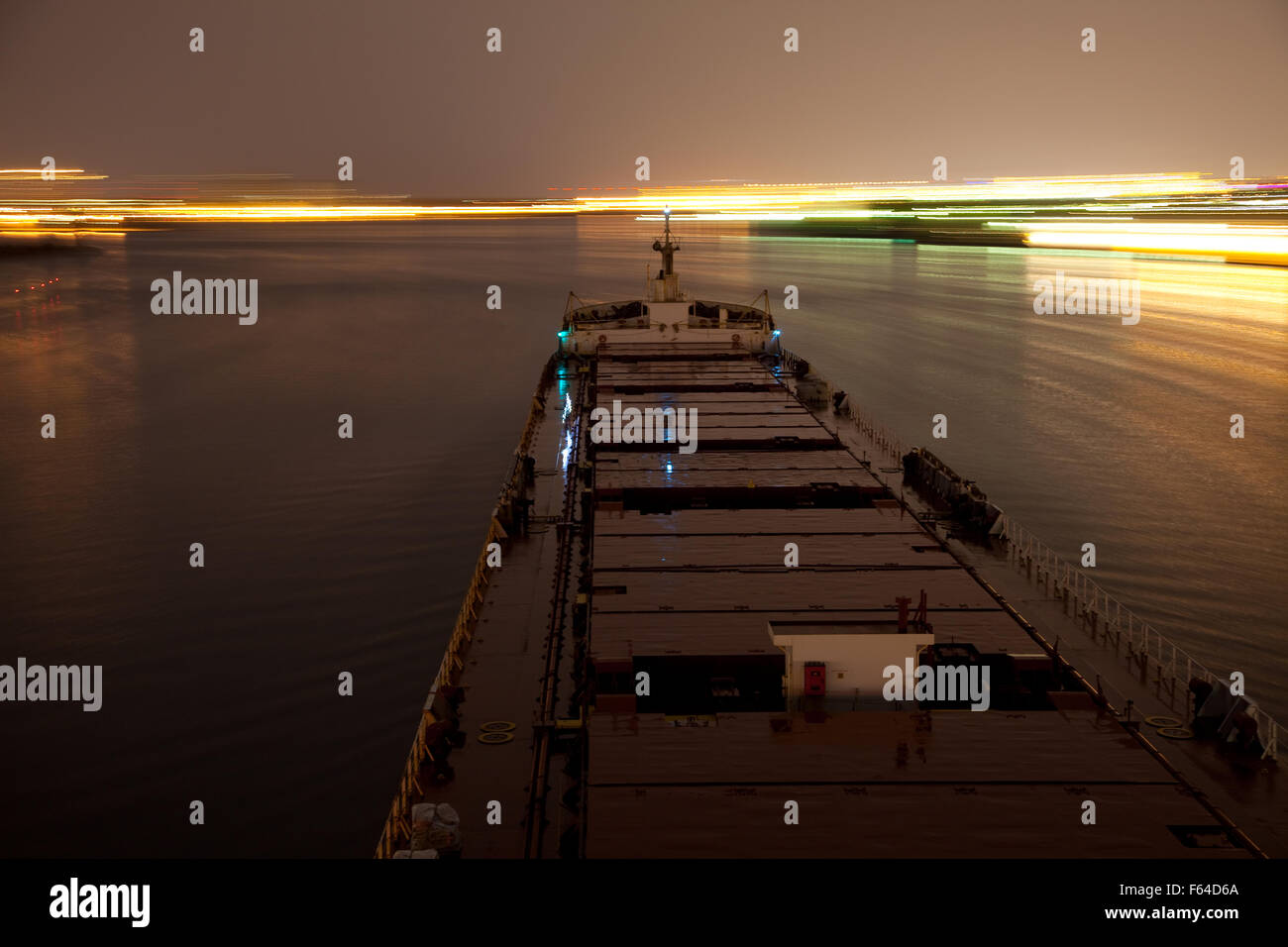 on a Laker Ship on the Great Lakes at night turning in the channel ...