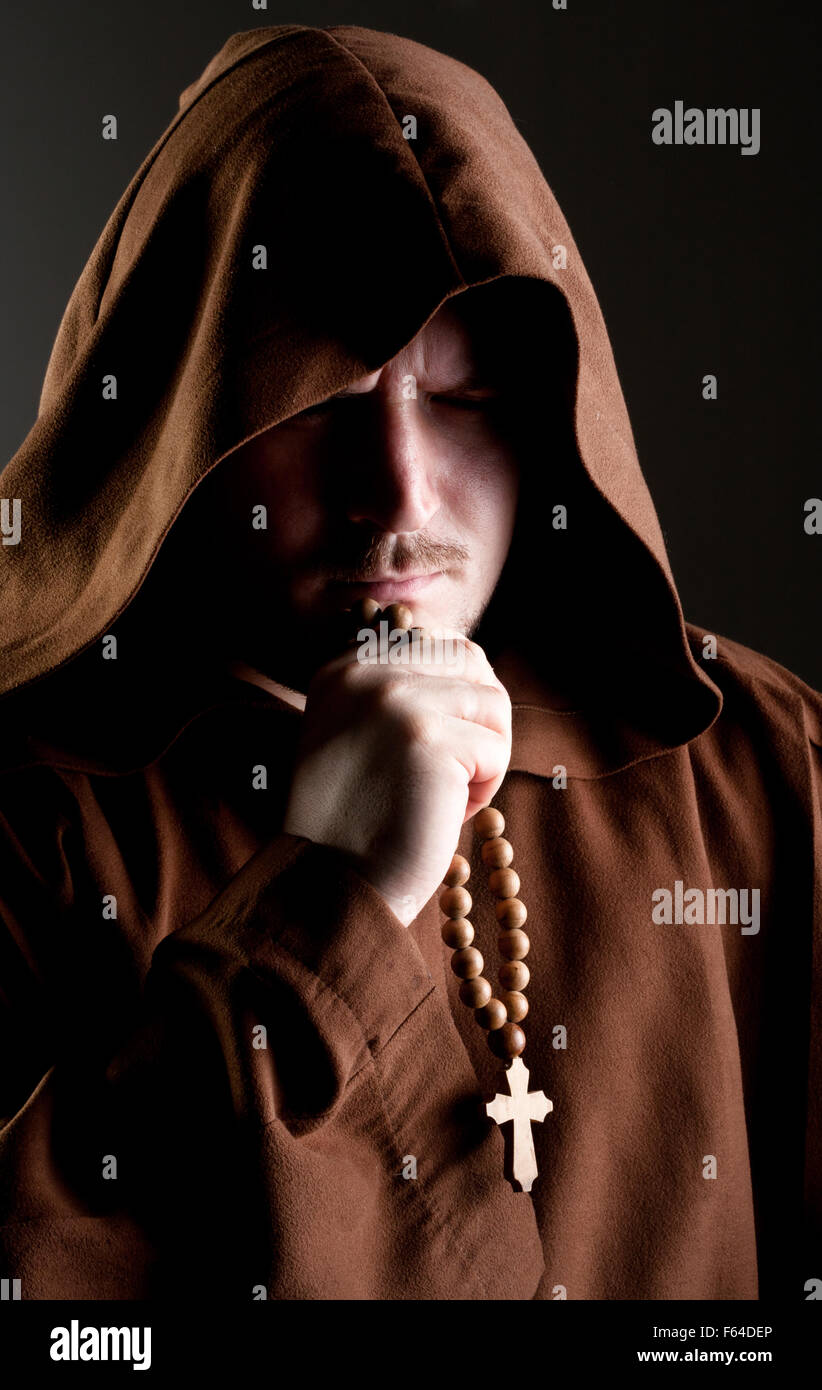 Portrait of medieval monk with cross rosary in shadow Stock Photo - Alamy
