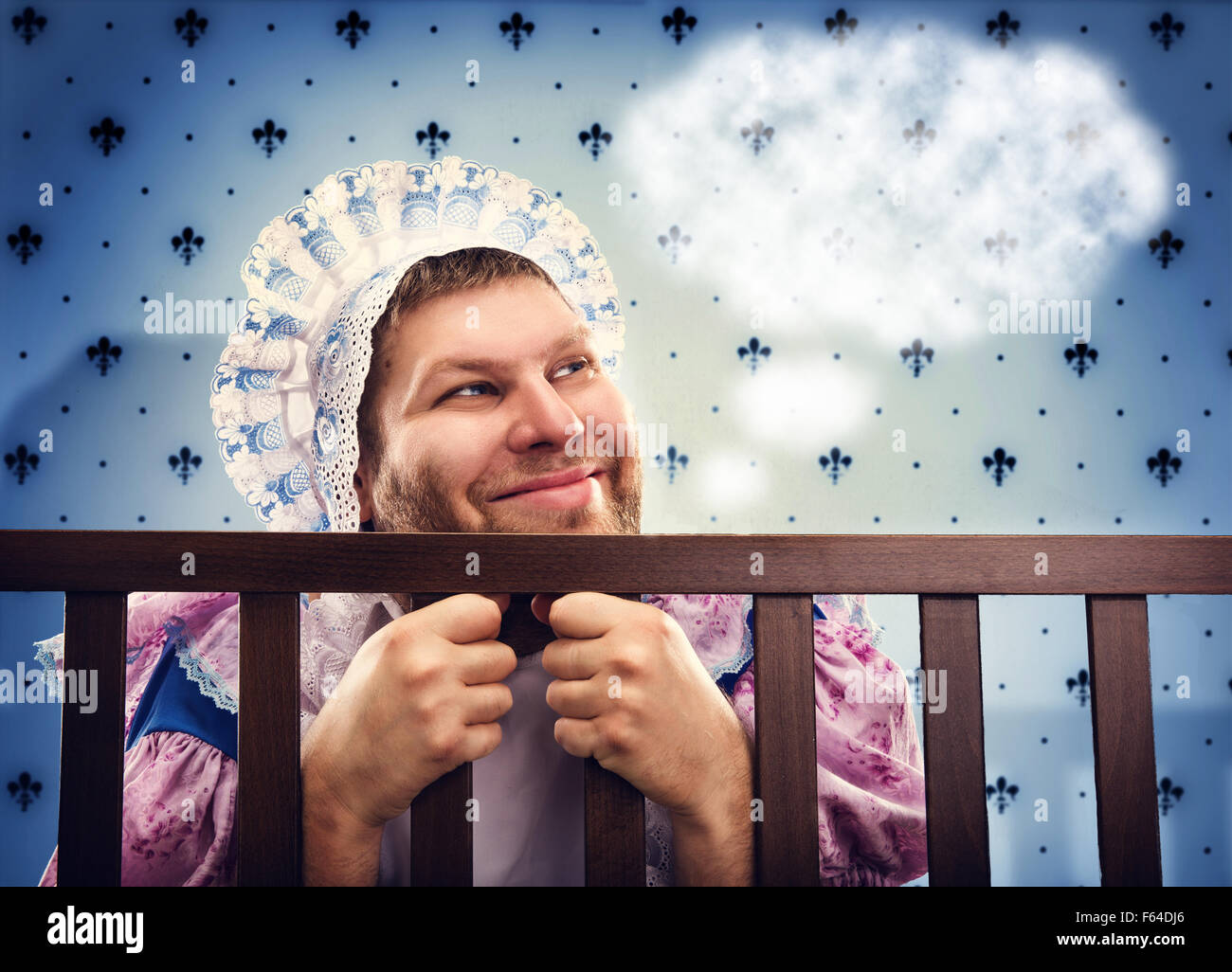 Man weared as baby in playpen is daydreaming Stock Photo - Alamy
