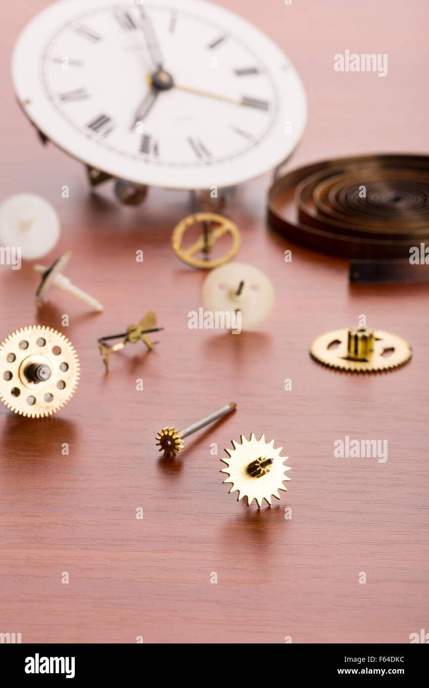 Many clock details on wooden table Stock Photo - Alamy