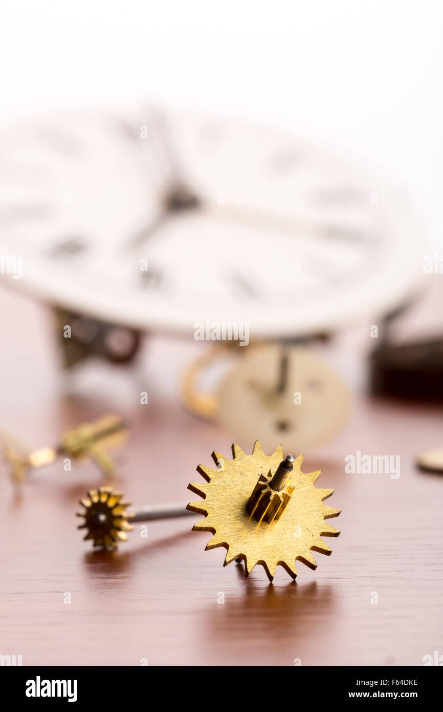 Lots of clock details on wooden table Stock Photo - Alamy